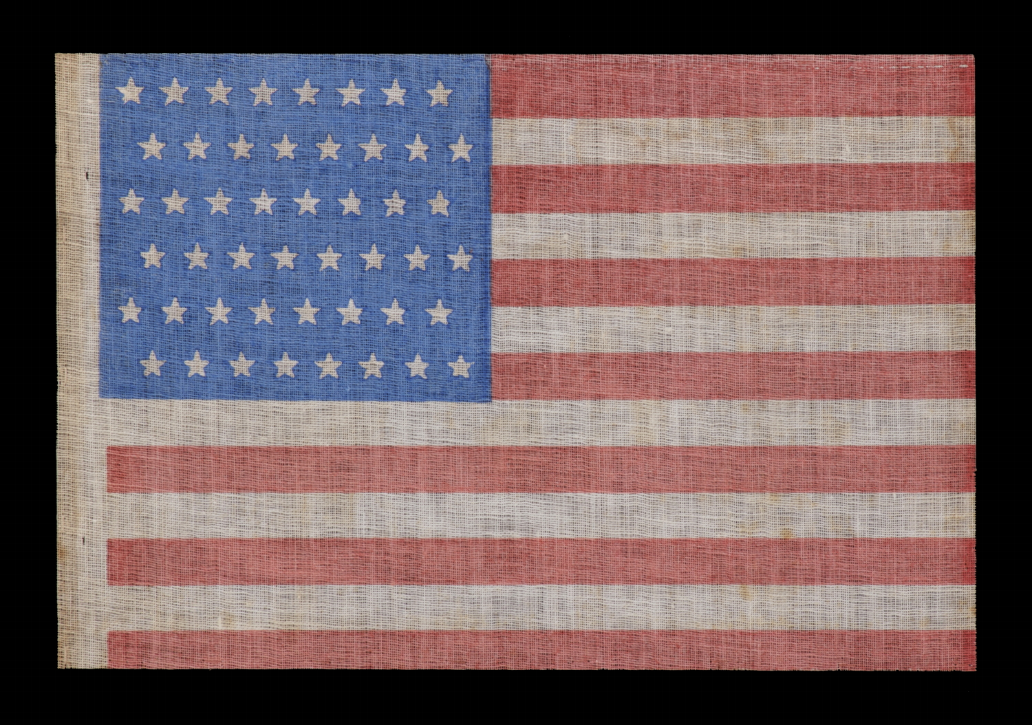 48 STARS IN STAGGERED ROWS ON AN ANTIQUE AMERICAN FLAG WITH A BRILLIANT ...